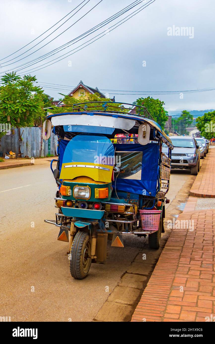 Typical colorful old tuk tuk rickshaw taxi in Luang Prabang Laos Stock ...