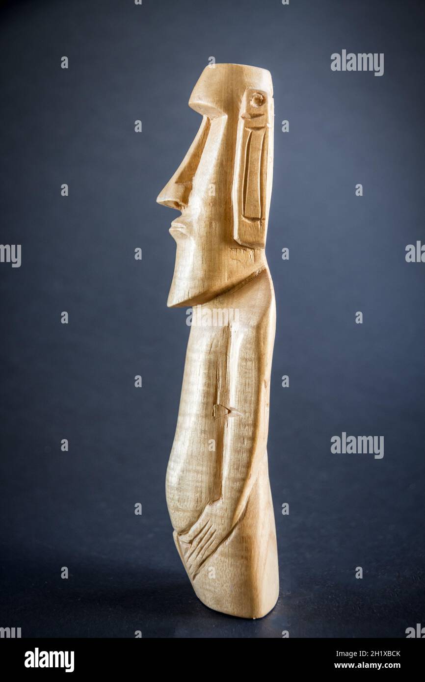 Traditional wooden statue of a moai from Easter Island. Dark background ...