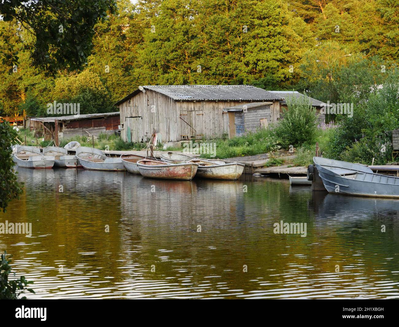 fishing boats old barn rural landscape river foreground Stock Photo - Alamy