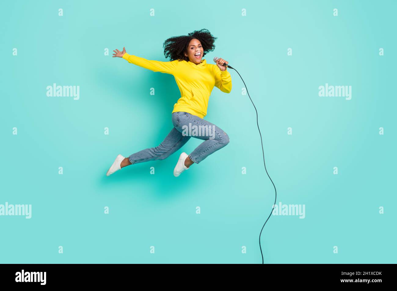 Full length body size photo woman jumping up singing in microphone ...