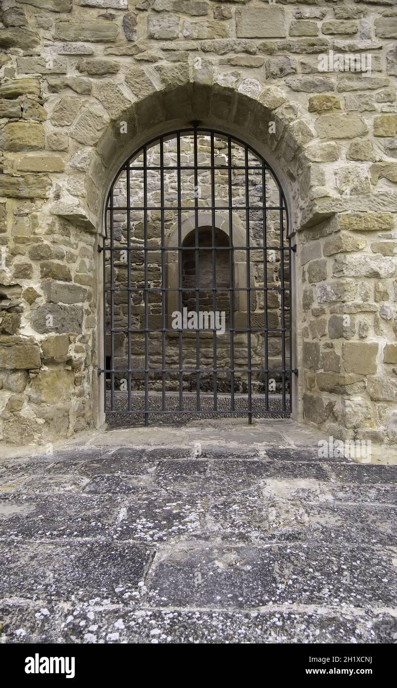 Detail of medieval arch closed with metal grill Stock Photo - Alamy