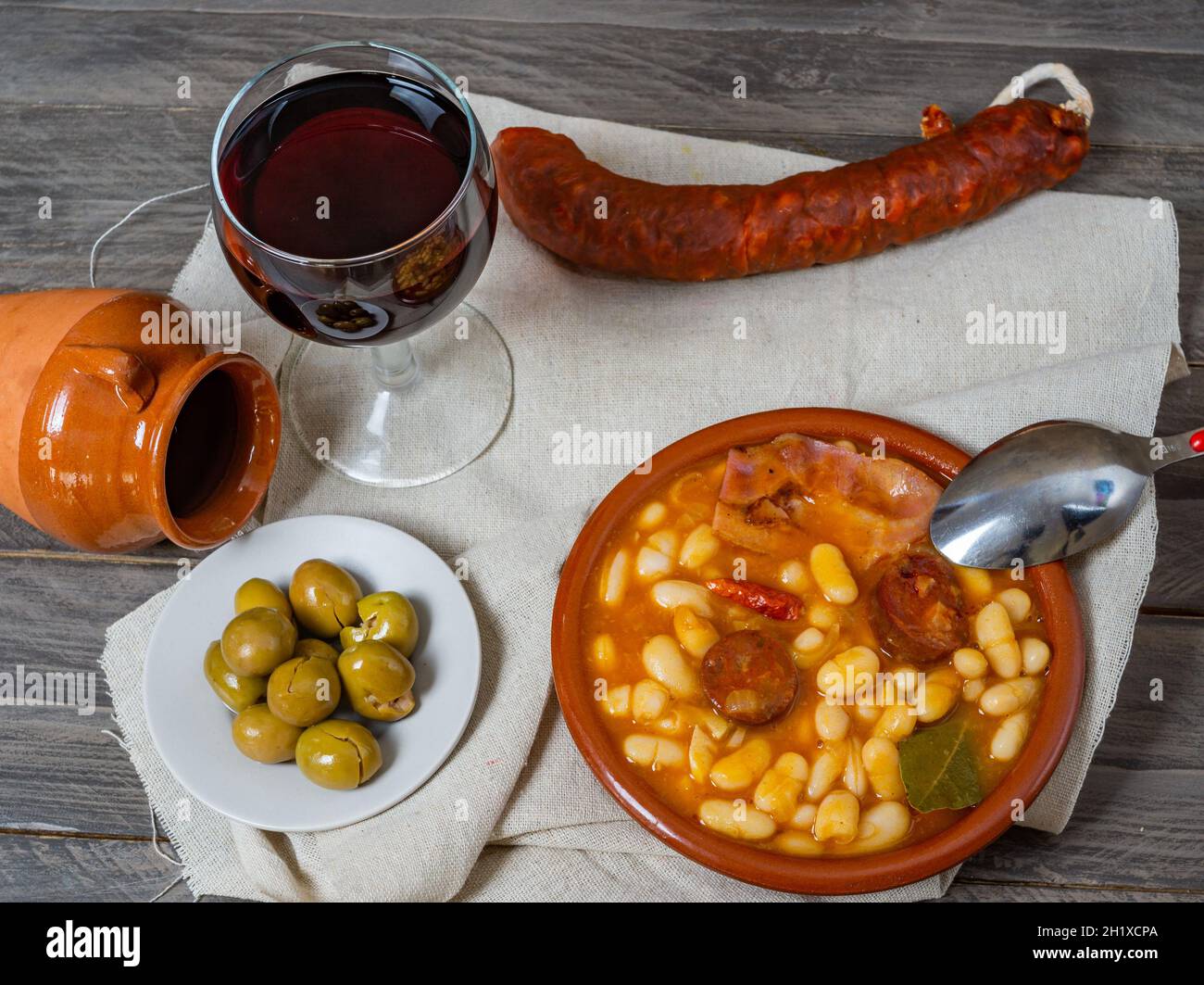 baked beans with garnish in different wood-bottomed containers Stock ...