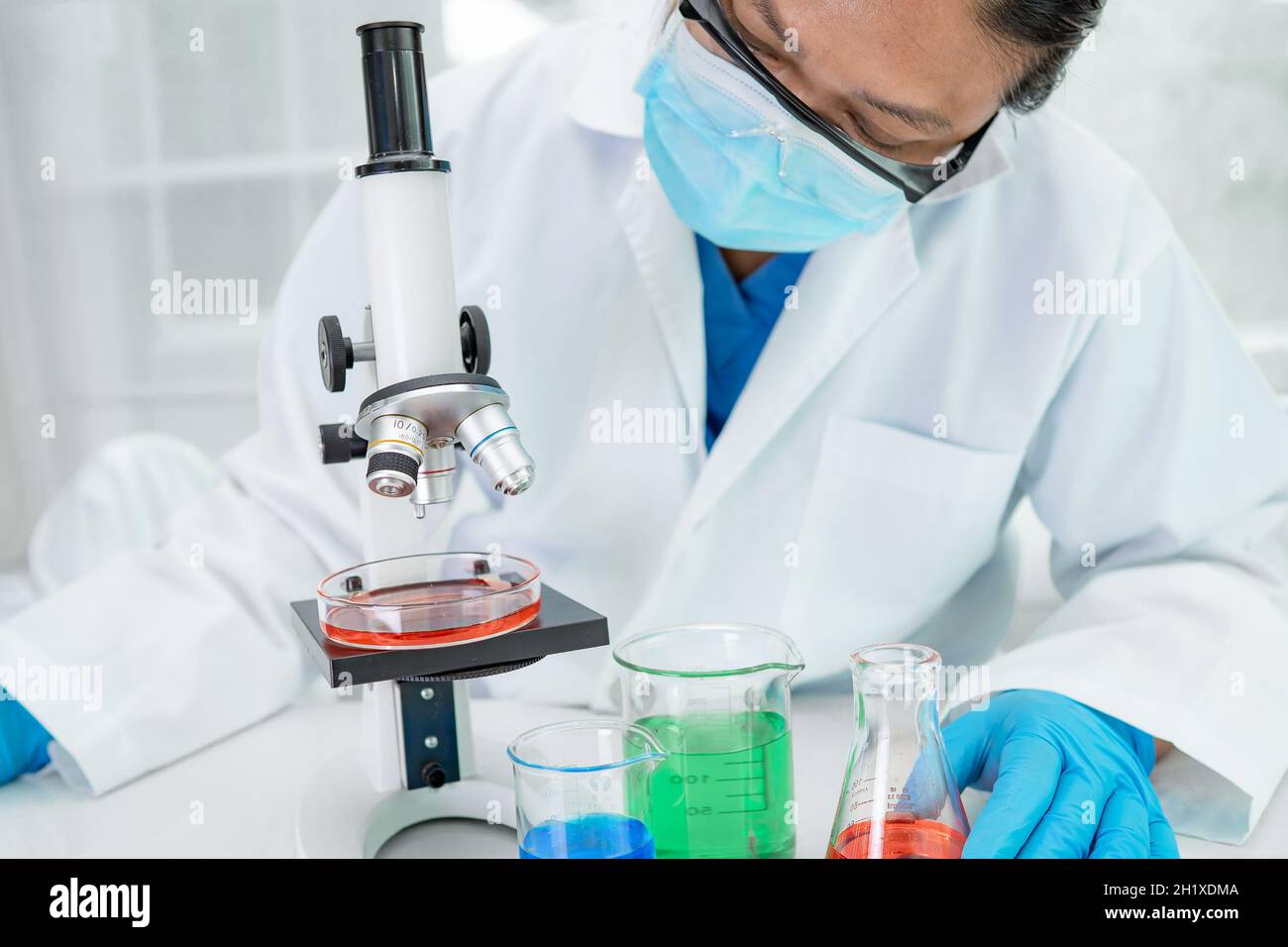 Asian scientist biochemist or microbiologist working research with a ...