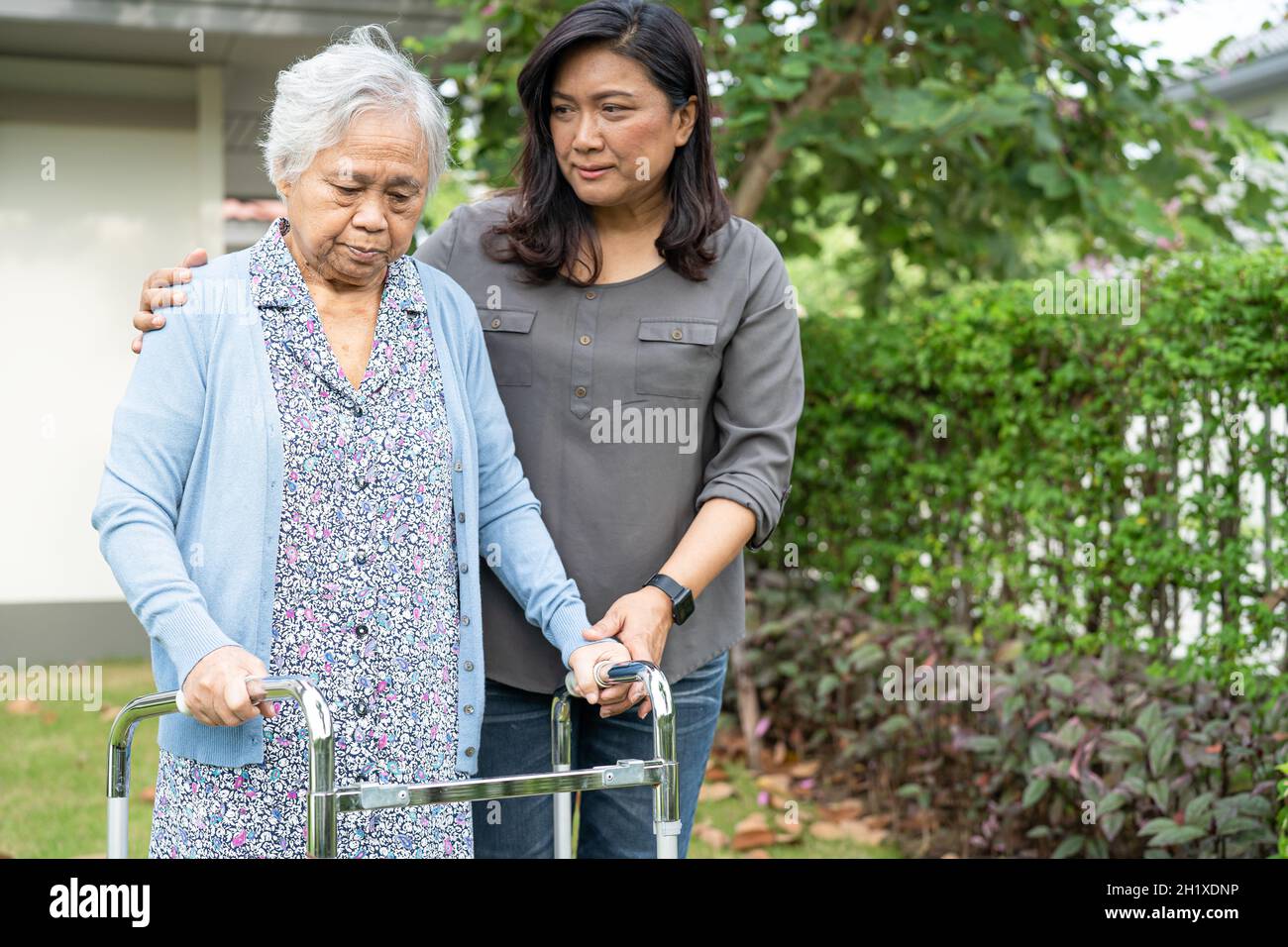 Help and care Asian senior or elderly old lady woman use walker with ...