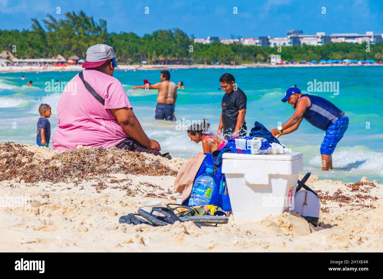 Fat Mexican man watches people while swimming and having fun in Playa ...