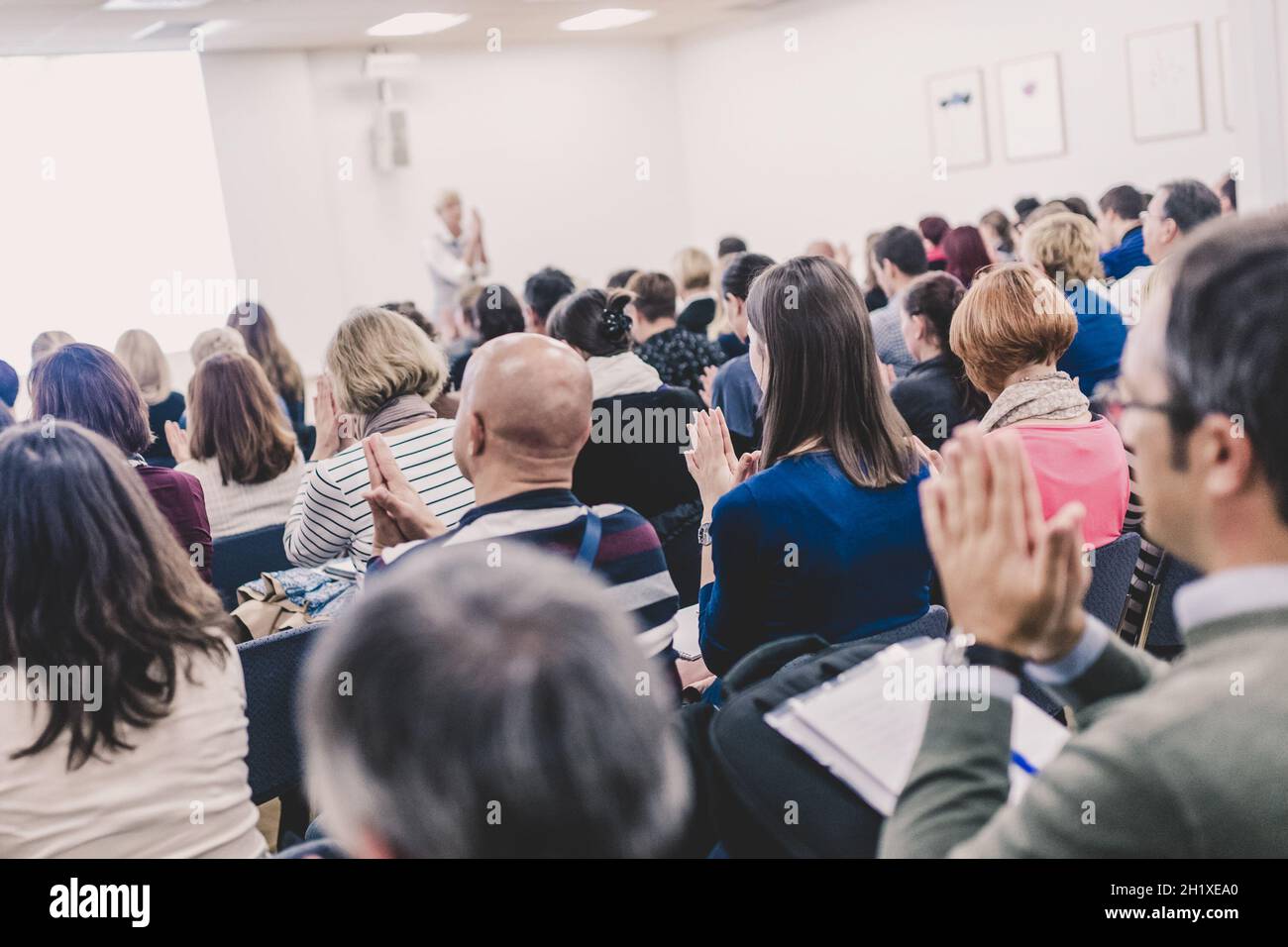 Life coaching symposium. Female speaker giving interactive motivational ...