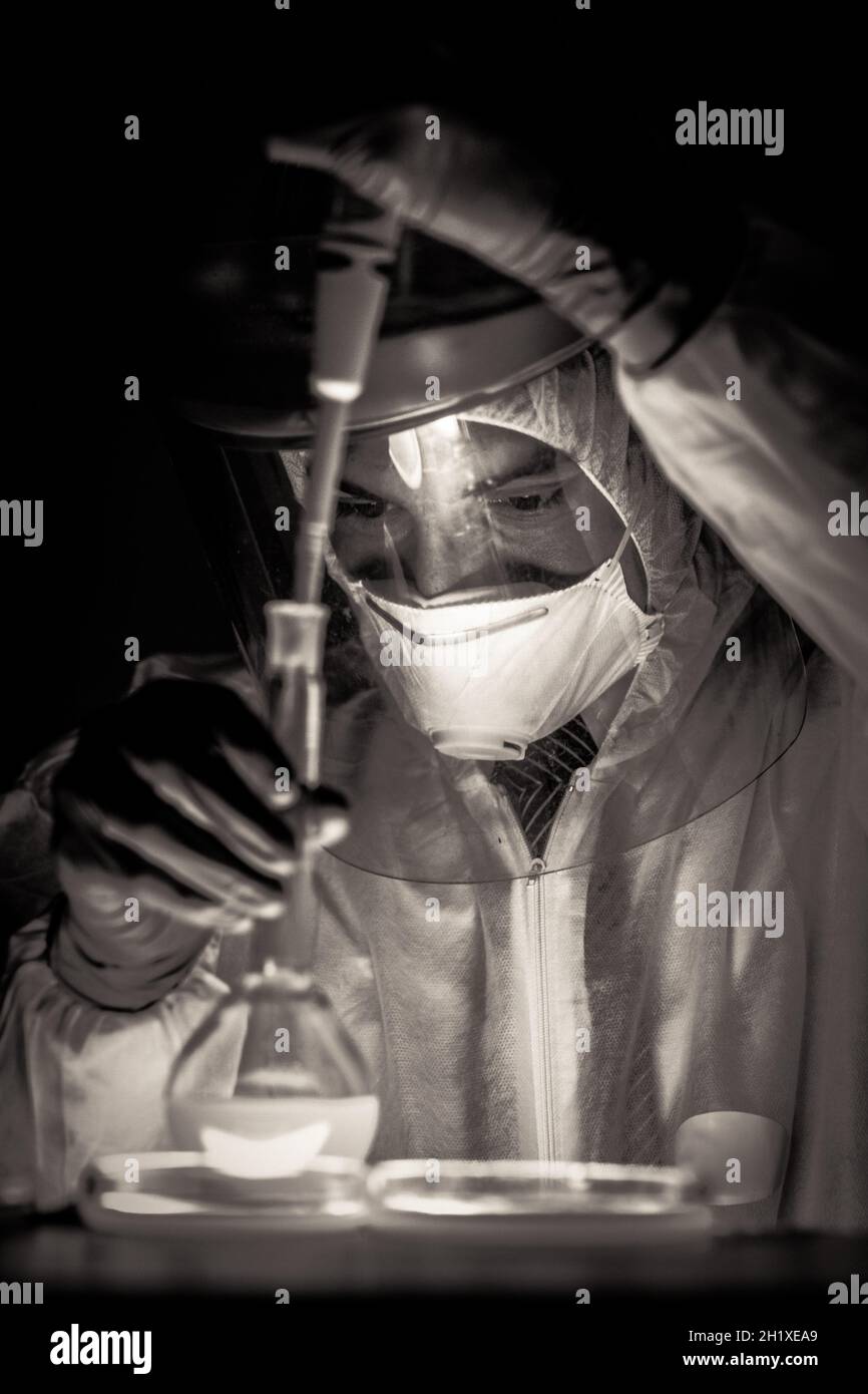Life scientist researching in bio hazard laboratory. Focused life ...