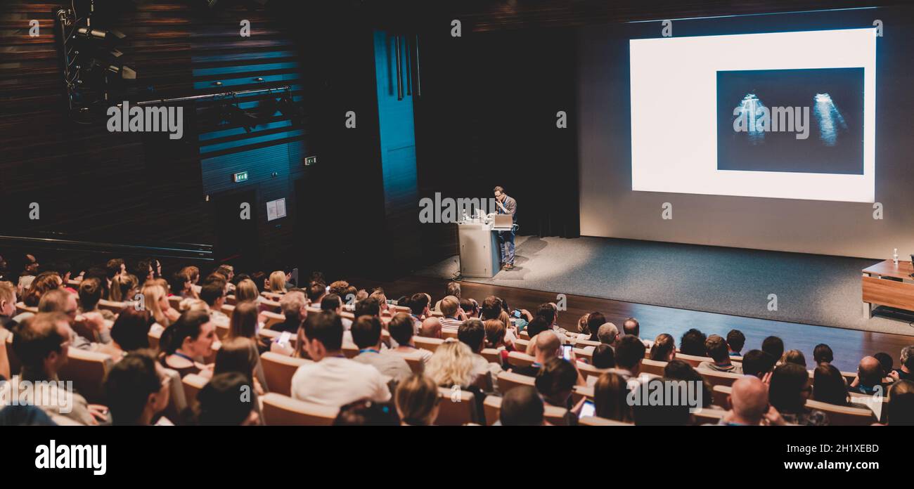 Speaker giving a talk on scientific conference. Audience at the ...