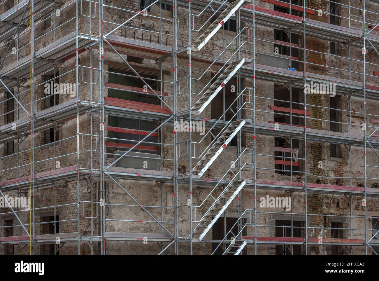 Scaffolding for a factory building to be renovated Stock Photo - Alamy