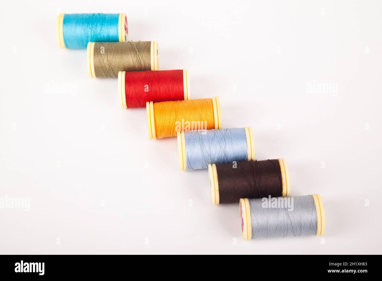 Spools and bobbins of thread for sewing in different colors, isolated ...