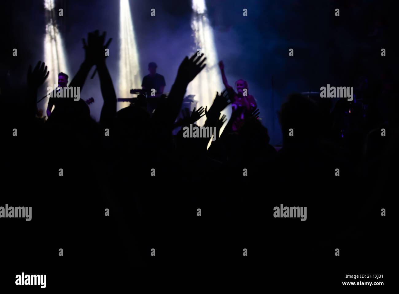 Crowd at concert - Cheering crowd in bright colorful stage lights Stock ...