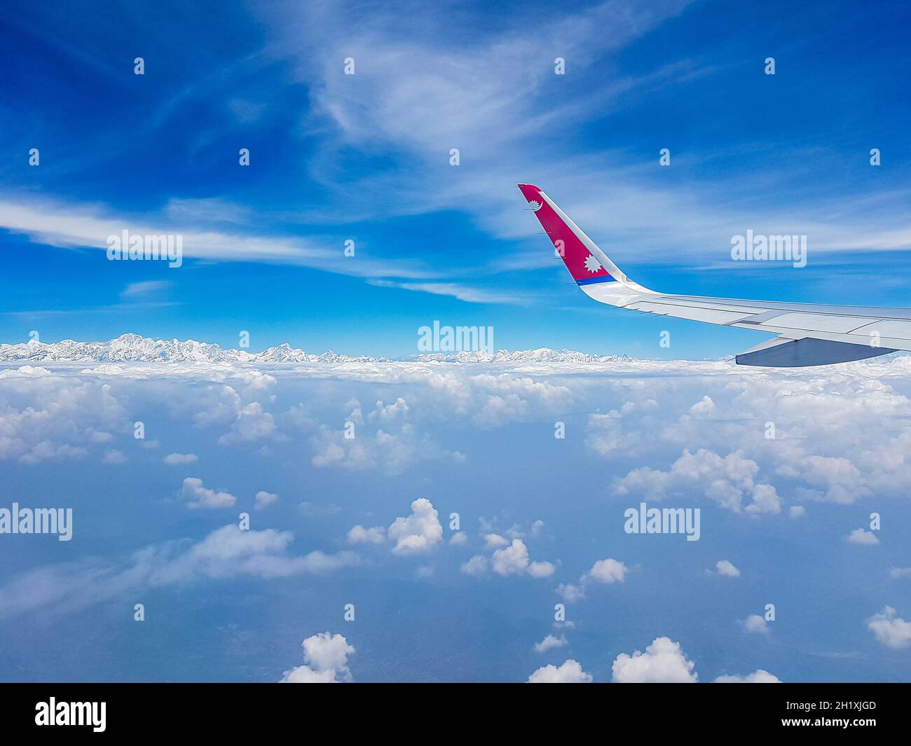 Nepal Airline aircraft wing, flight above Mount Everest in the ...