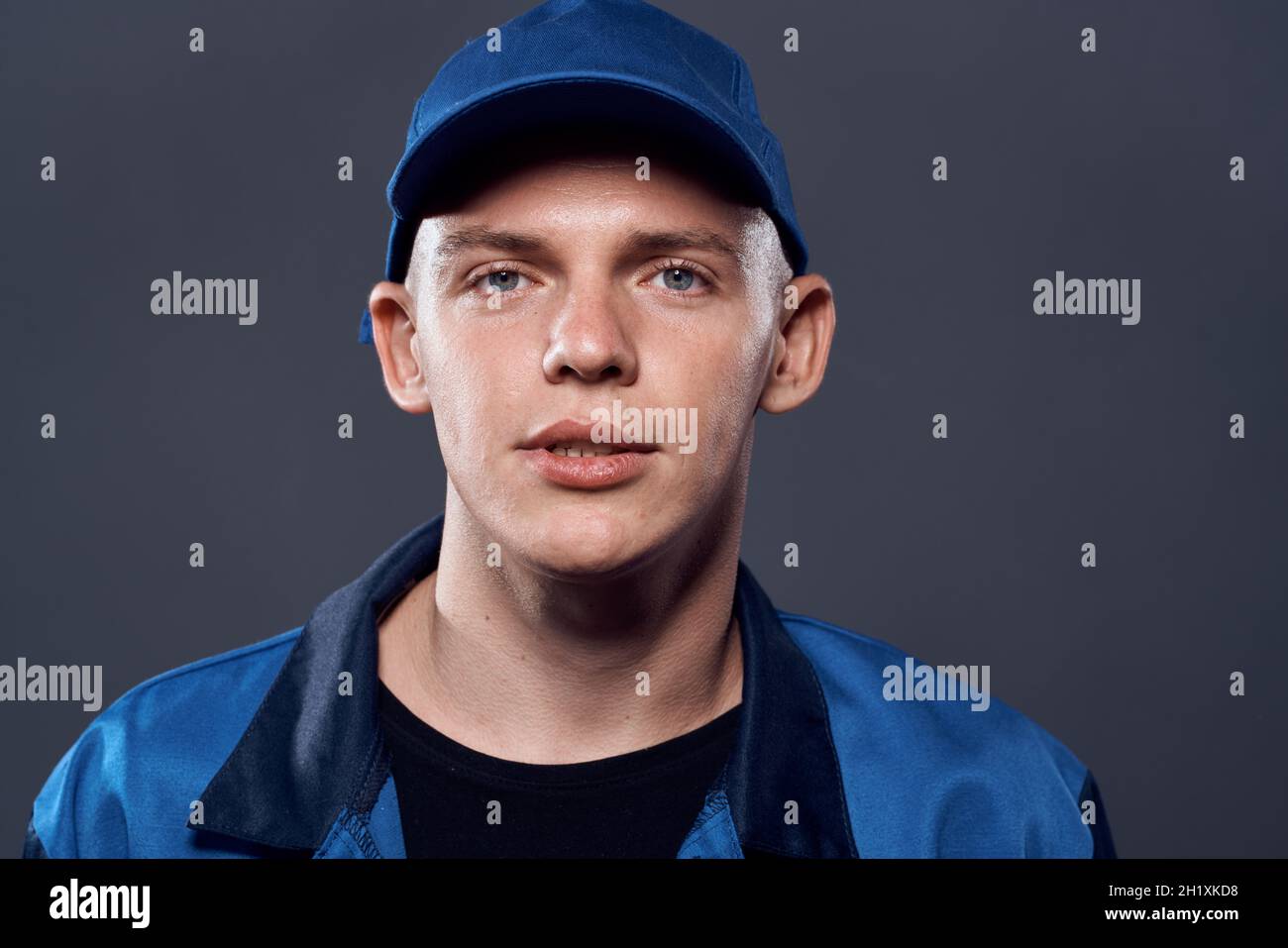 man in work uniform blue cap close-up of service Stock Photo - Alamy