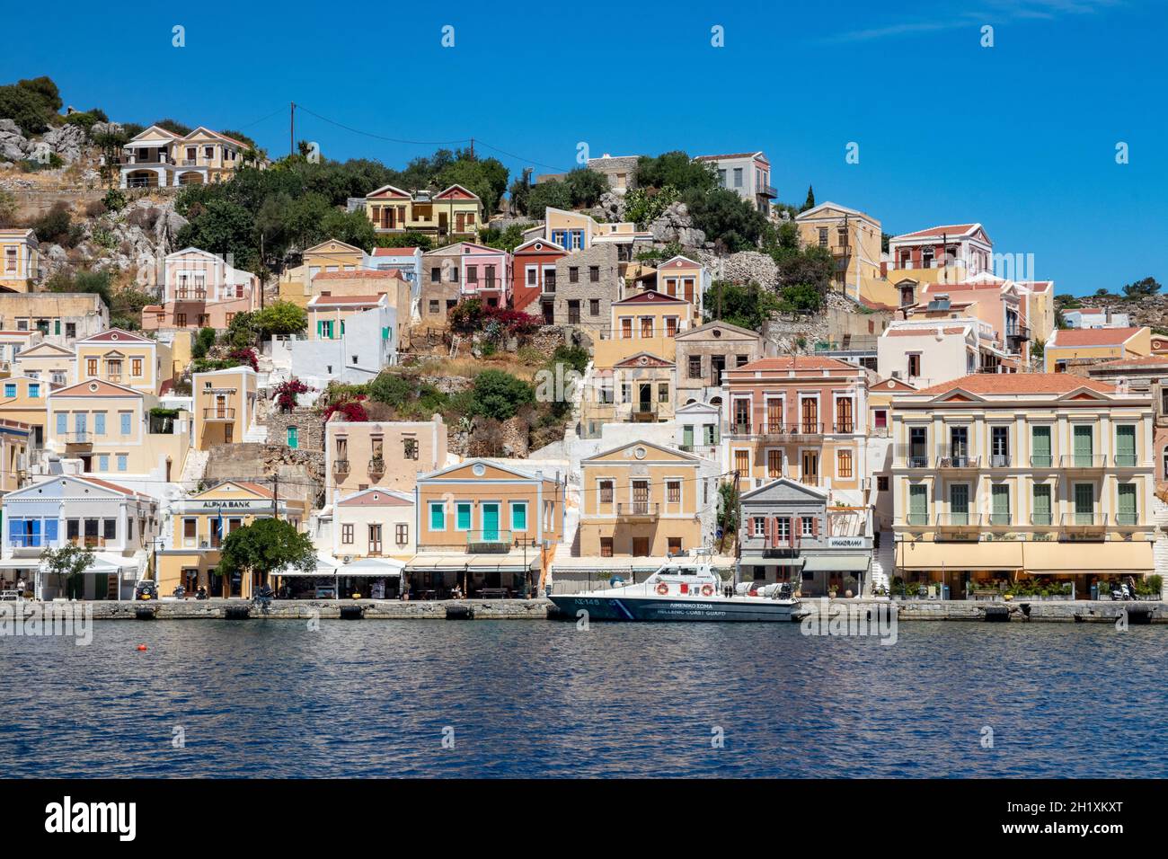 SYMI, Greece - JUN 03, 2021. The harbour of Symi town with the ...