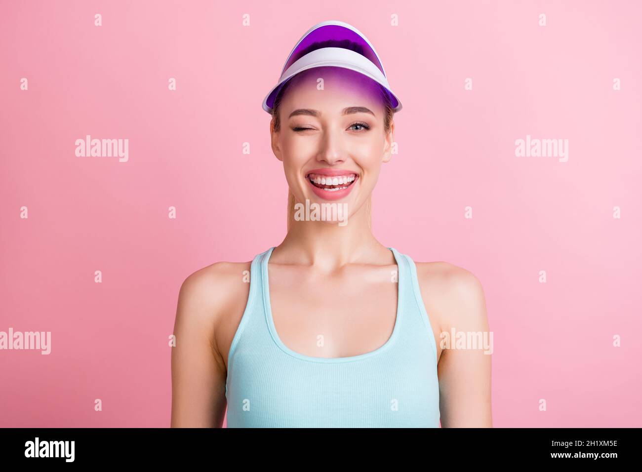 Photo of adorable flirty young lady wear turquoise tank-top winking ...