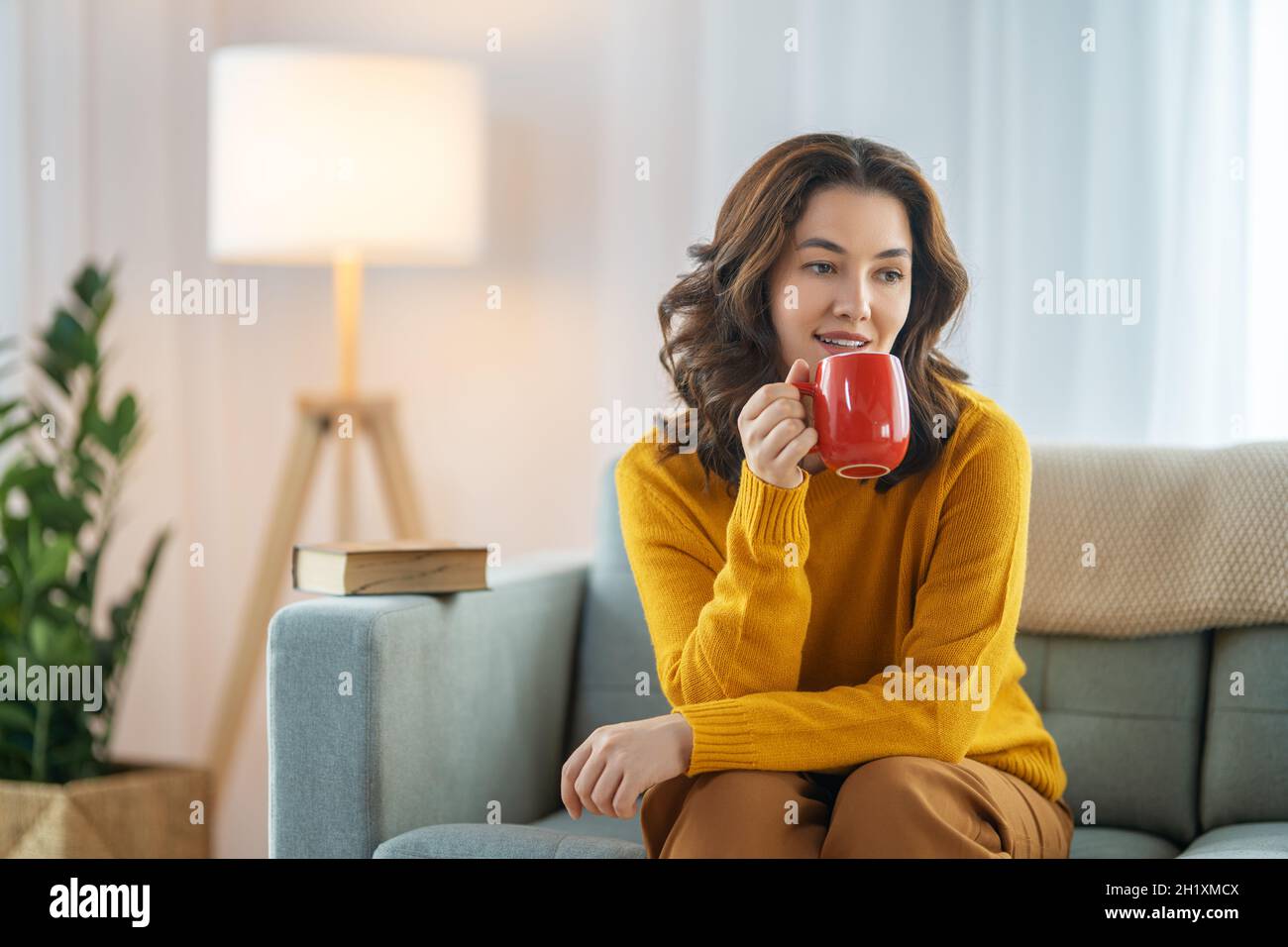 Beautiful young woman enjoying tea hi-res stock photography and images ...