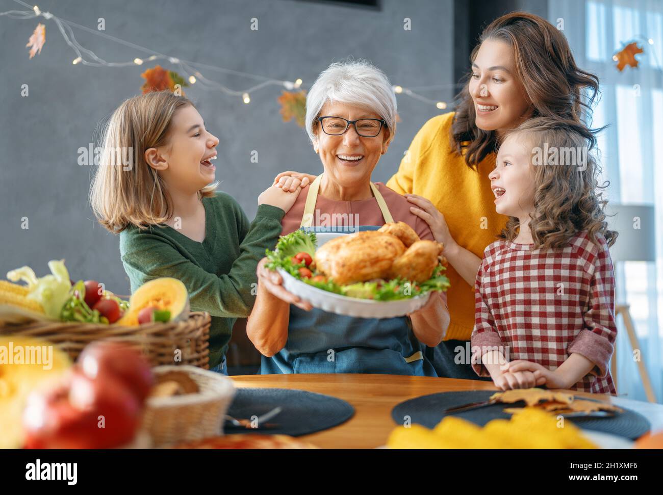 Thanksgiving Day, Autumn feast. Happy family sitting at the table and ...
