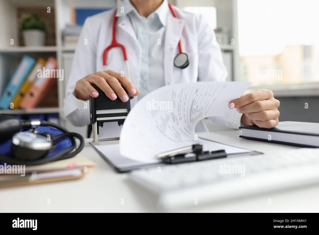 Doctor puts a stamp on medical documents closeup Stock Photo - Alamy