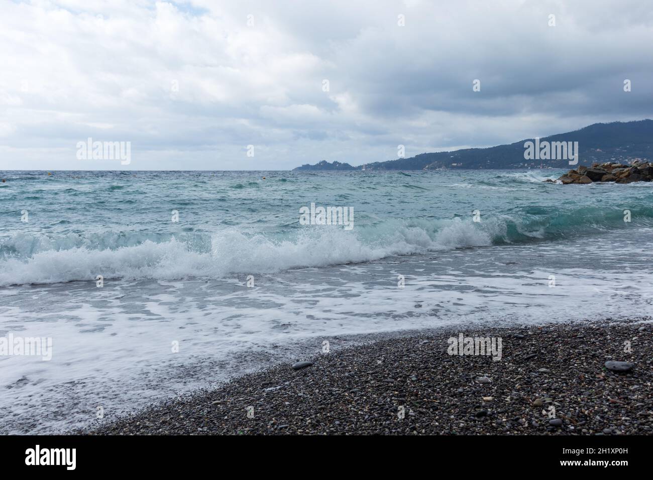 Rough sea and clouds in Tigullio Gulf, Italy. On the background the ...
