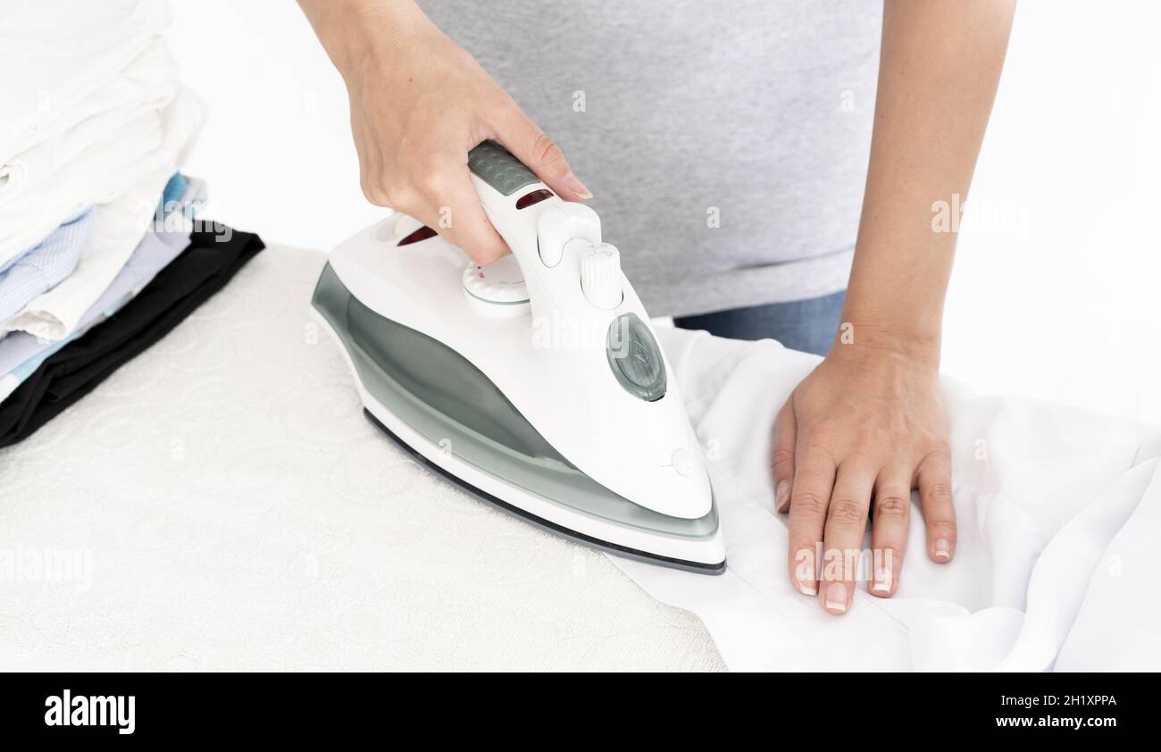 unrecognisable lady ironing clothes. Resolution and high quality ...