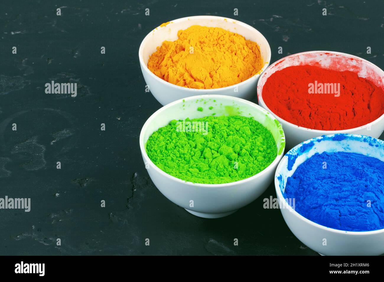 Indian Holi festival colours in small bowls on dark background Stock ...