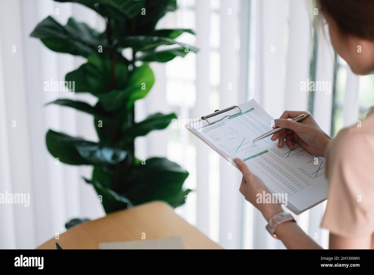 Close up accounting woman working with paperwork and calculate the ...