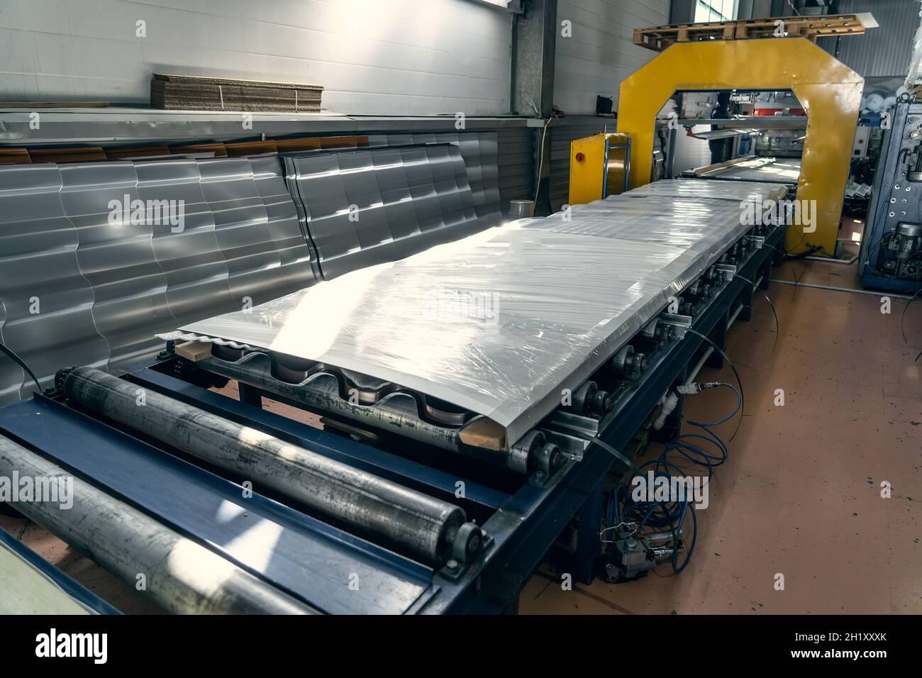 Conveyor belt or line with finished packaged metal roof tiles ...