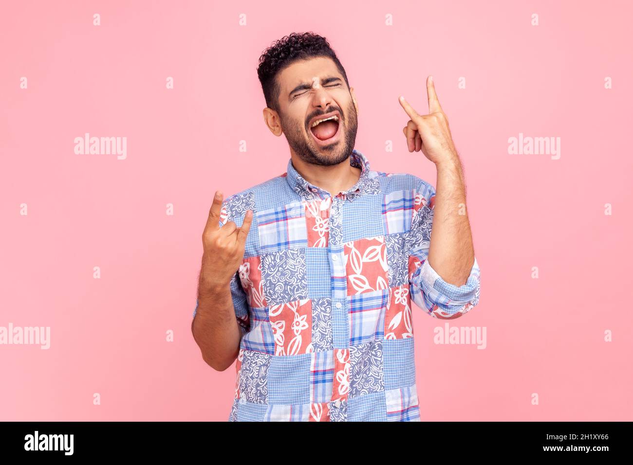Rock n roll. Funny young adult bearded man wearing blue casual style ...
