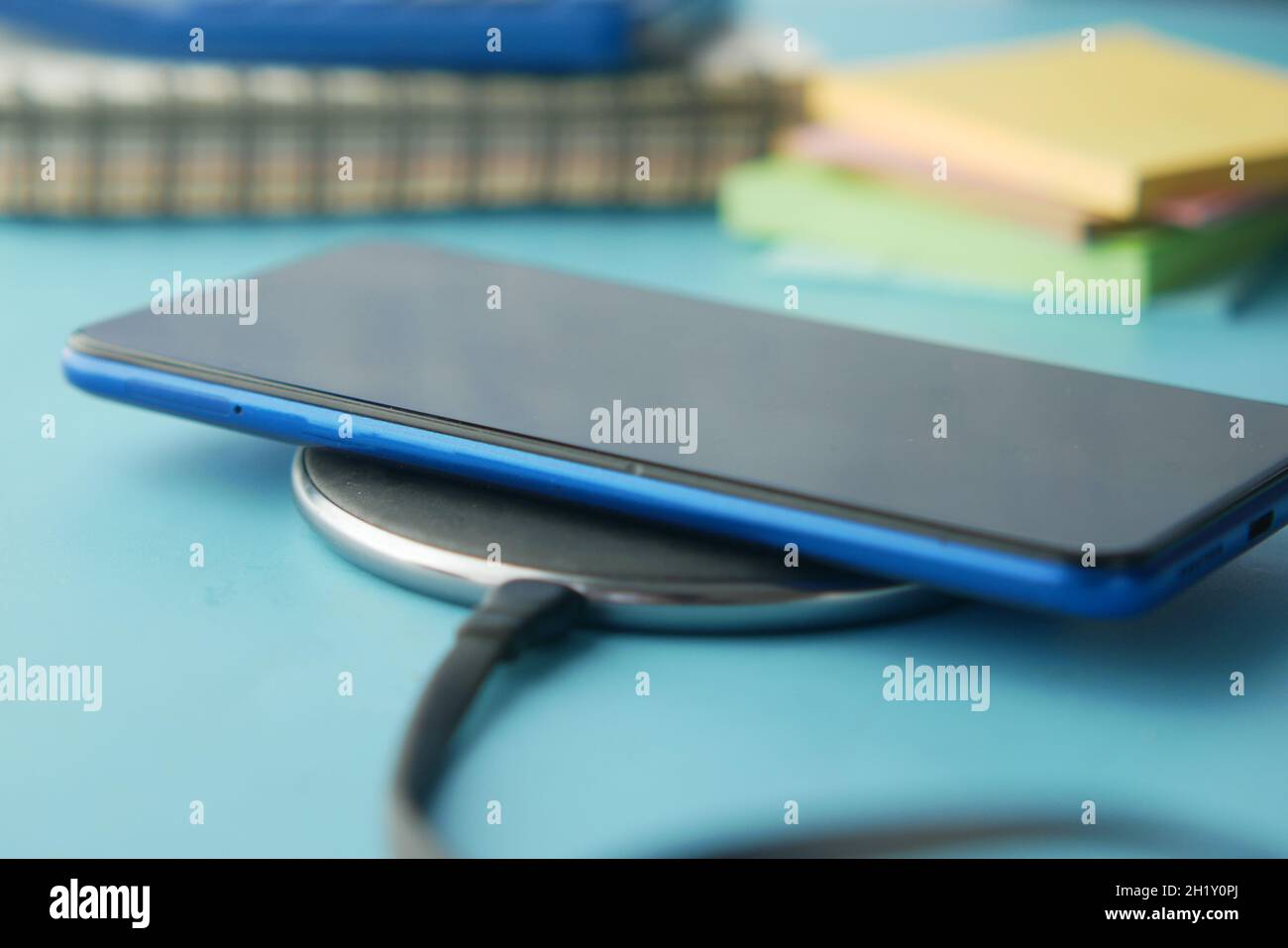 charging Smartphone using Wireless Charging Pad, top view Stock Photo ...