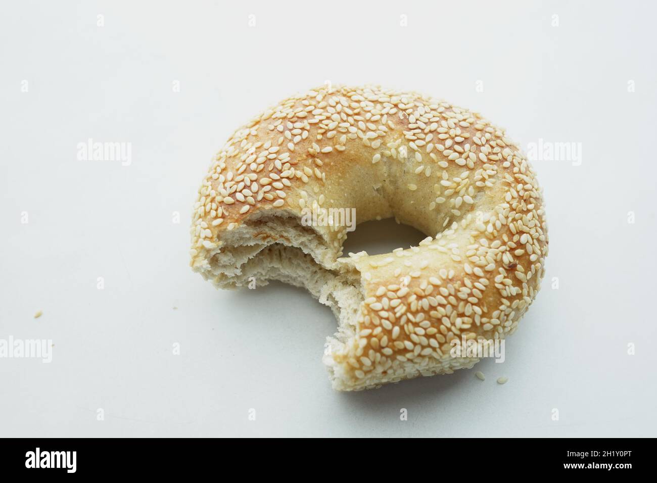 half eaten bagel on white background Stock Photo - Alamy