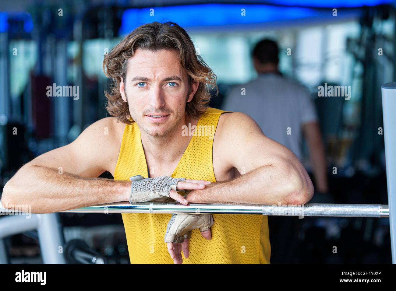 Man taking a break in a weight room at the gym Stock Photo - Alamy