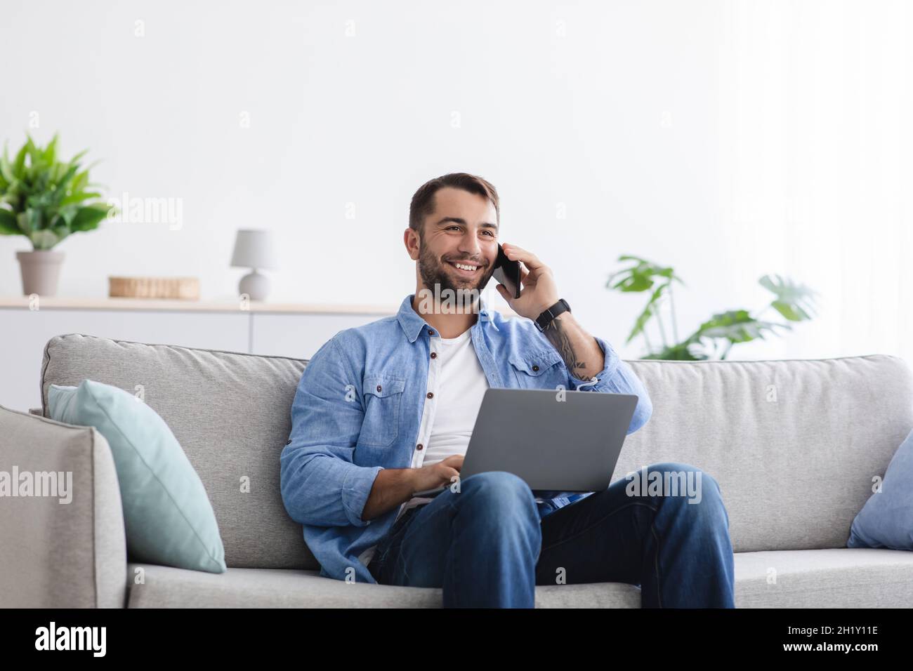 Cheerful Handsome Mature Caucasian Guy With Beard Talking By Phone With