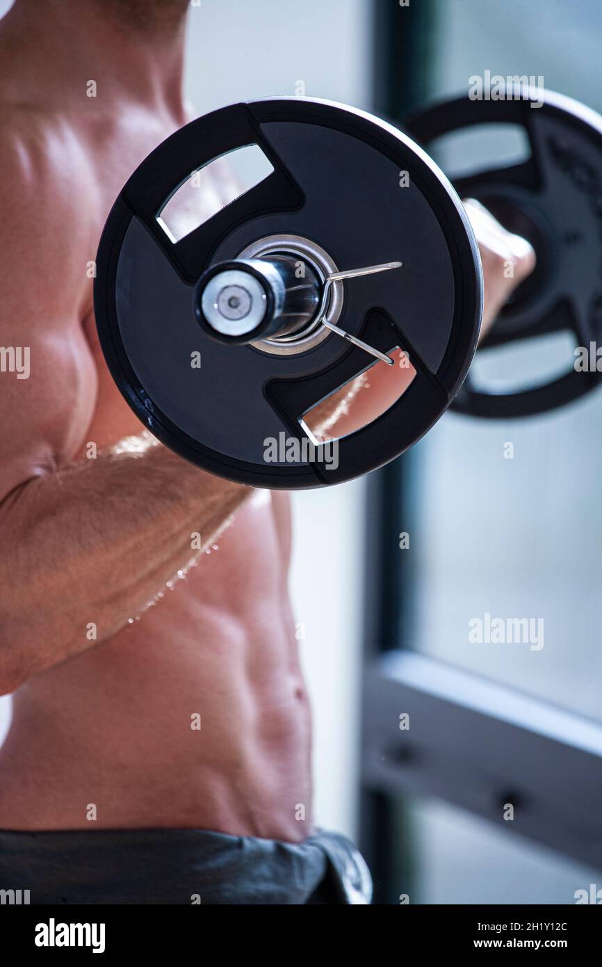 Strong men lifting dumbbells hi-res stock photography and images - Alamy