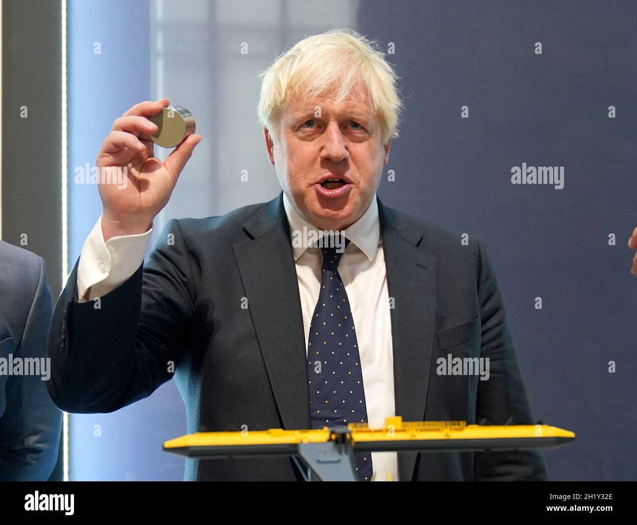 Prime Minister Boris Johnson (centre) looks at the Orbital Marine Power ...
