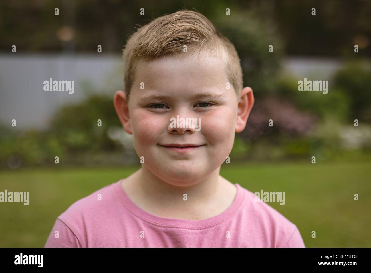 Little boy standing in garden hi-res stock photography and images - Alamy