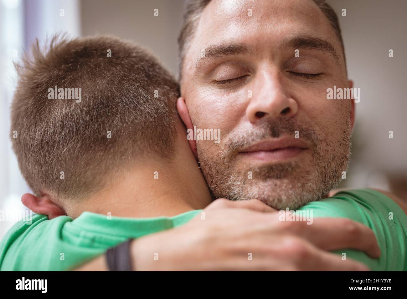 Close up view of caucasian father hugging his son at home Stock Photo ...