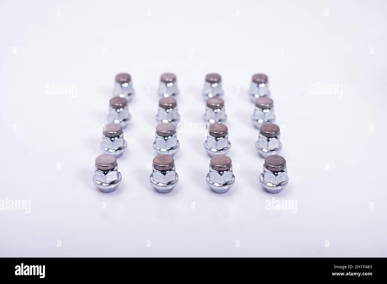 Chrome metal shiny wheel lug nuts set Stock Photo - Alamy
