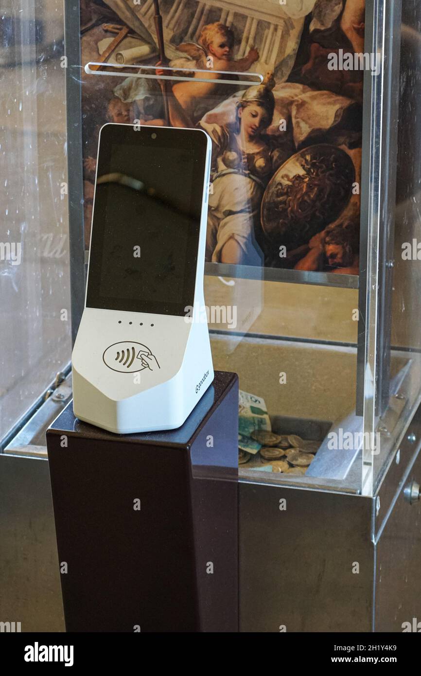 Donation box with card reader inside church Stock Photo - Alamy