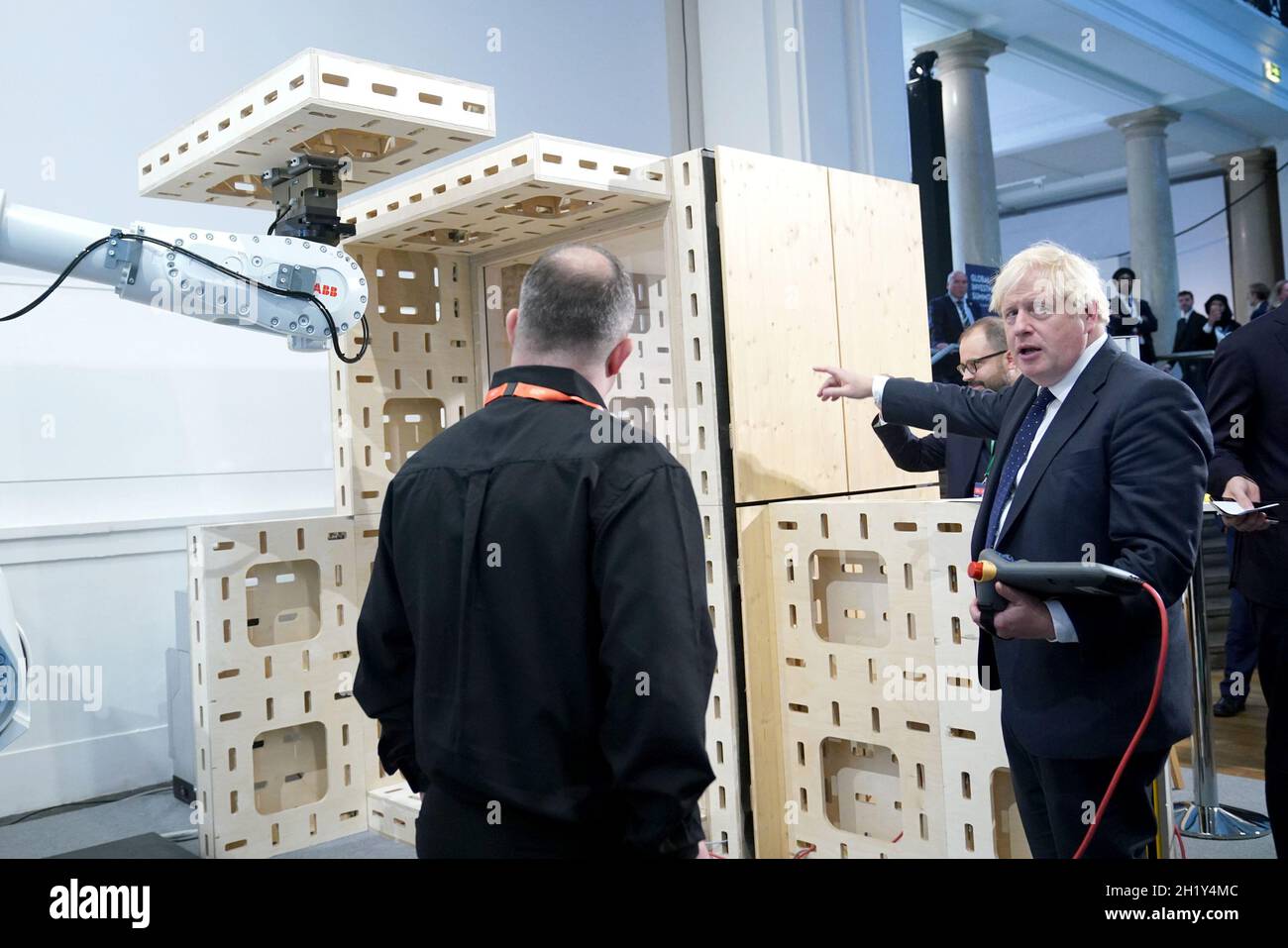 Prime Minister Boris Johnson operating a robot arm at the Auar ...