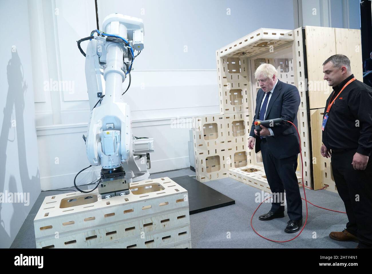 Prime Minister Boris Johnson operating a robot arm at the Auar ...