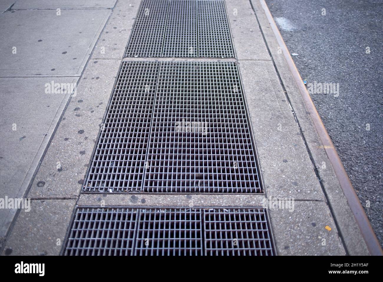 Subway vents on a sidewalk alongside a city street Stock Photo - Alamy