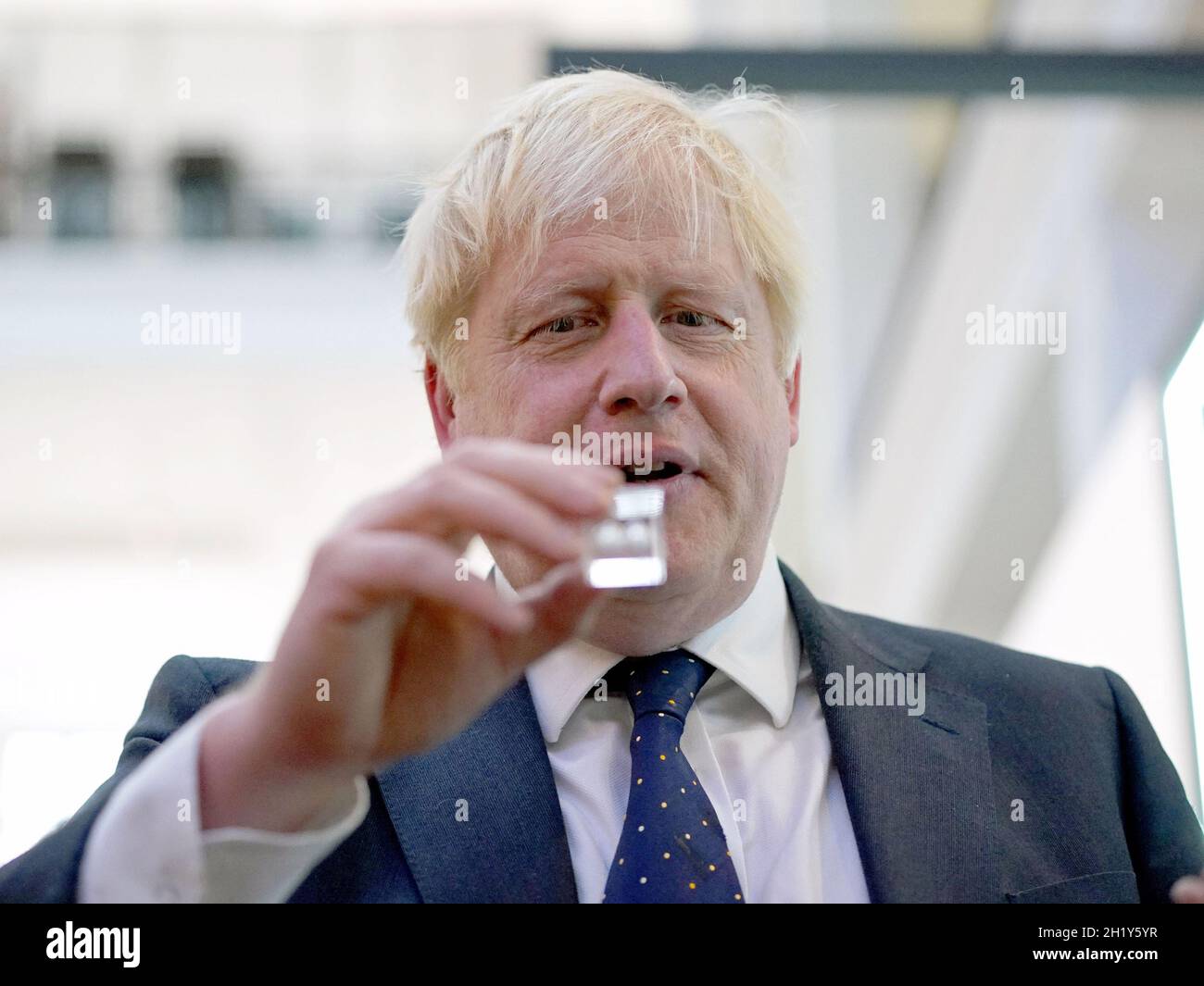 Prime Minister Boris Johnson looks at a product from the First Light ...