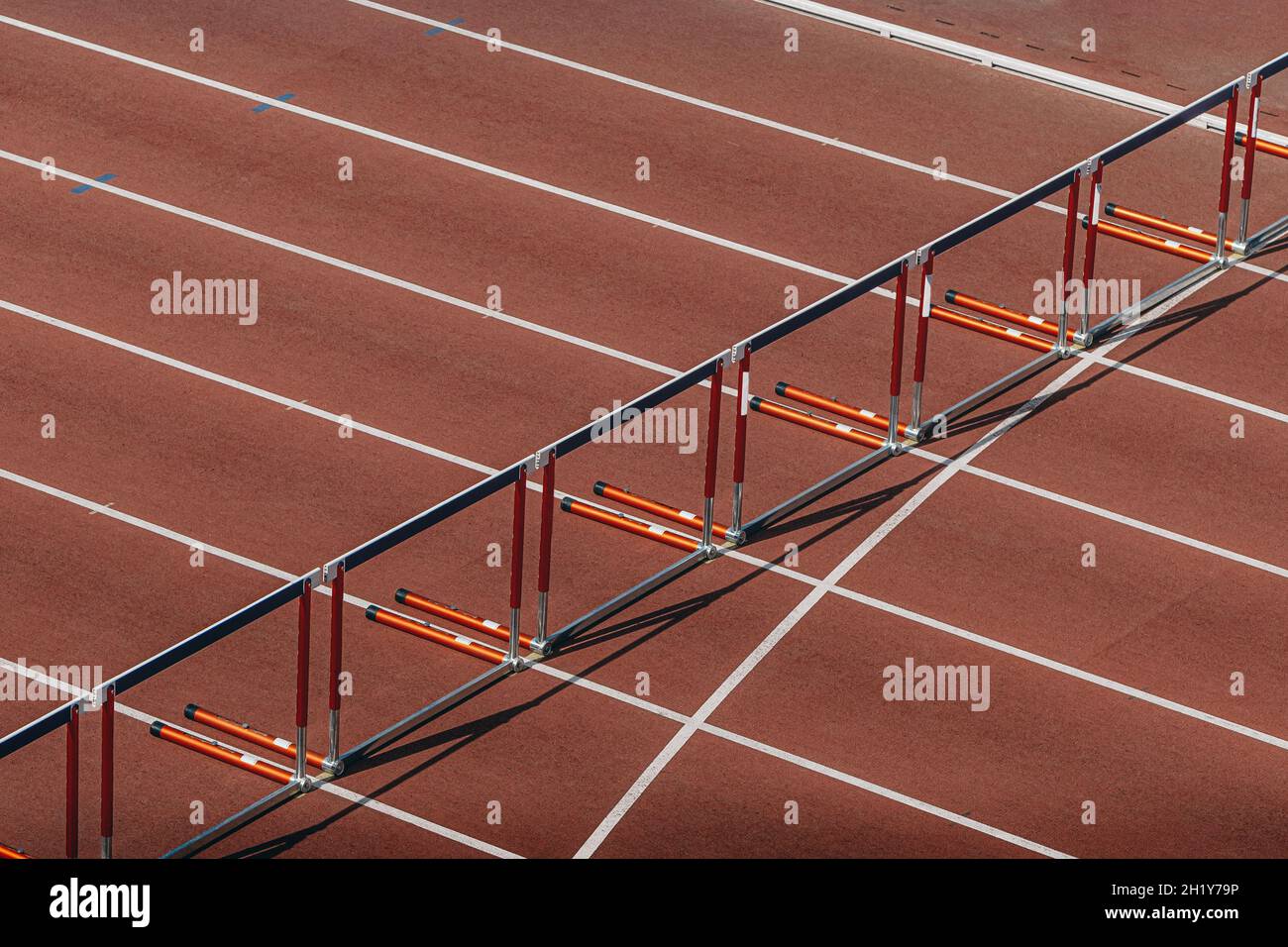 hurdles for running 110 meters on red track of stadium Stock Photo - Alamy