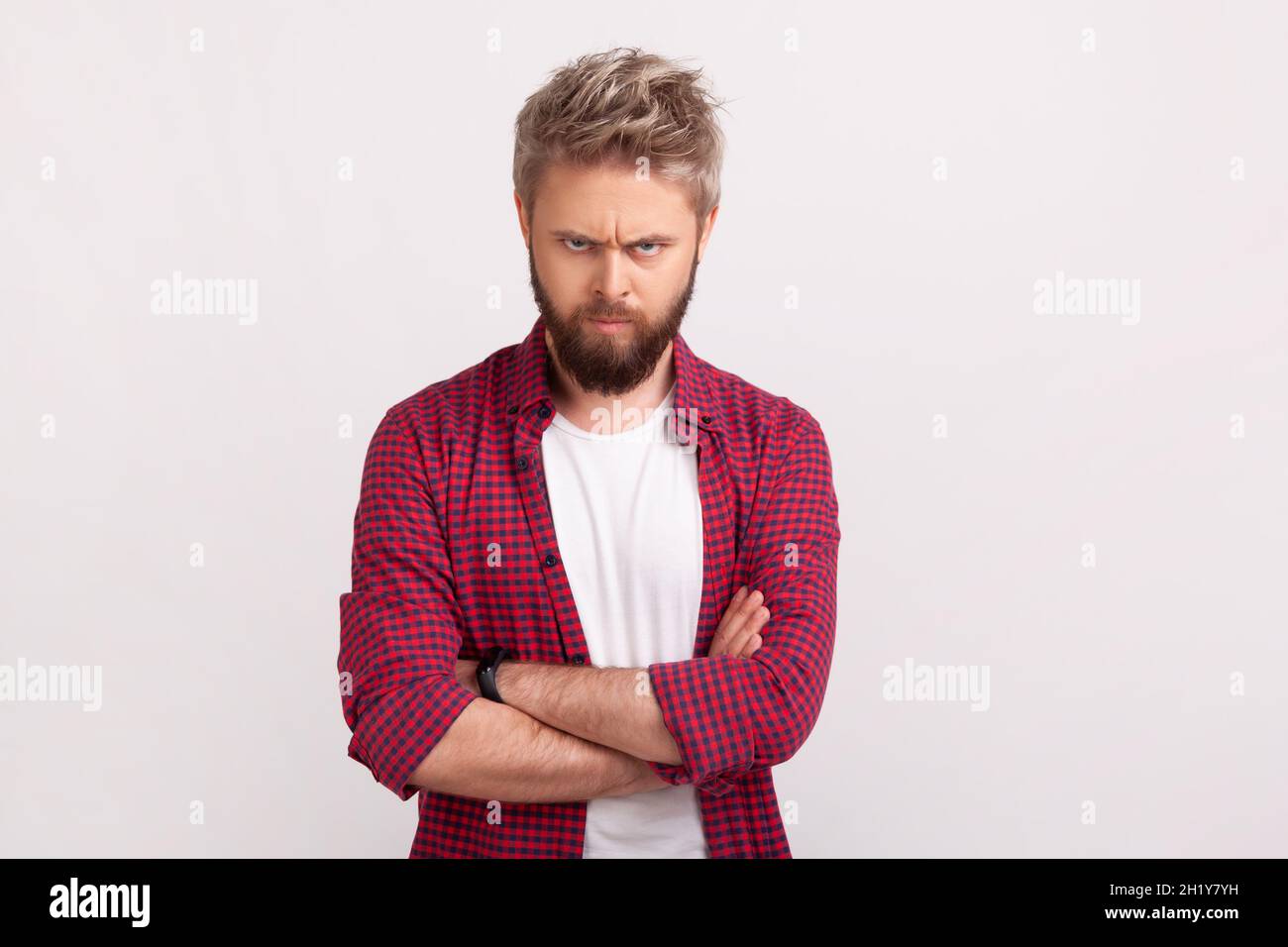 Portrait of aggressive bossy bearded man with grumpy face and folded ...
