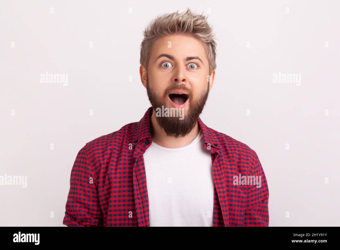 Portrait of extremely surprised caucasian bearded man looking at camera ...