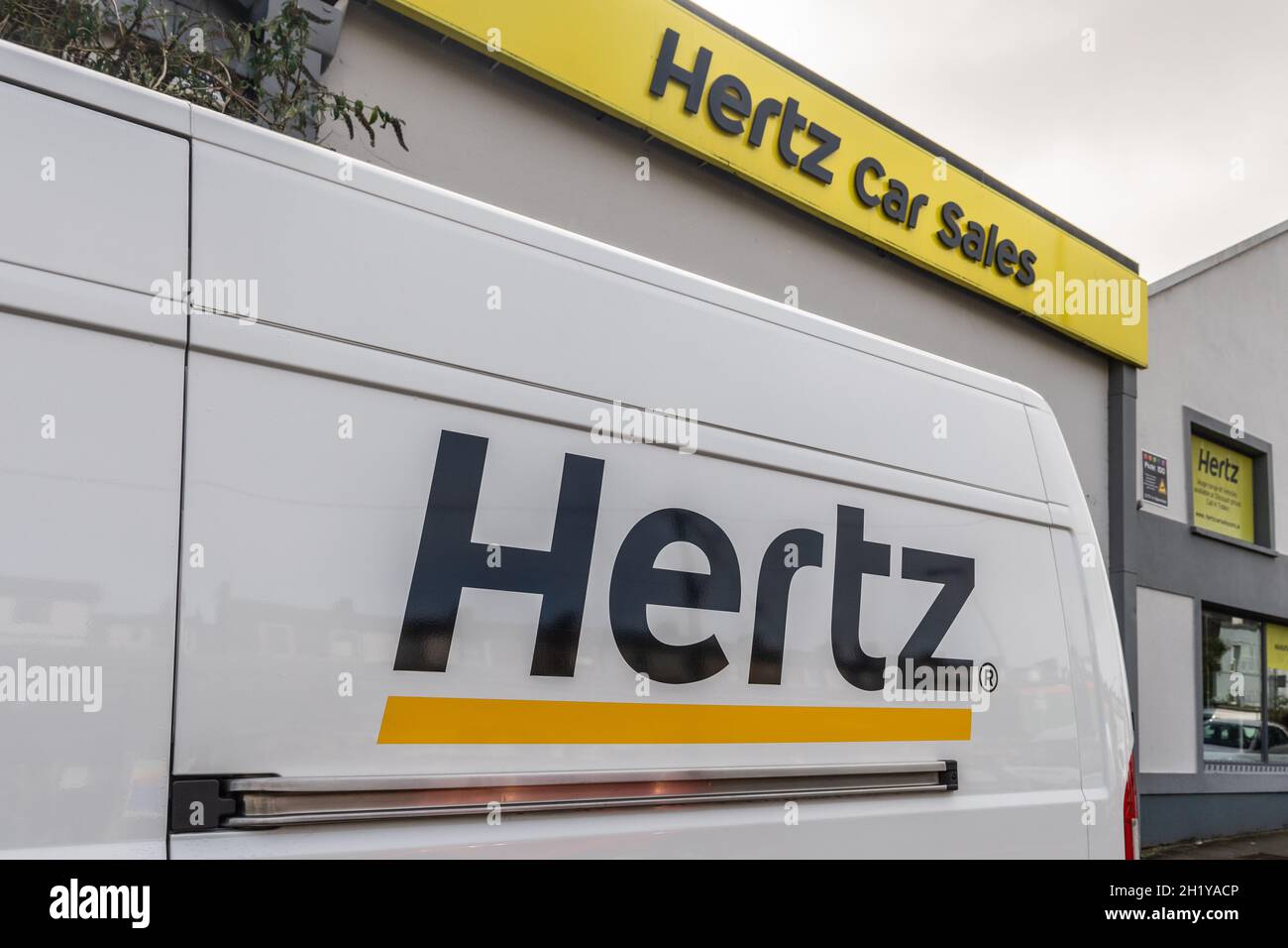 Hertz logo on the side of a van outside a Hertz Car Sales Branch in ...