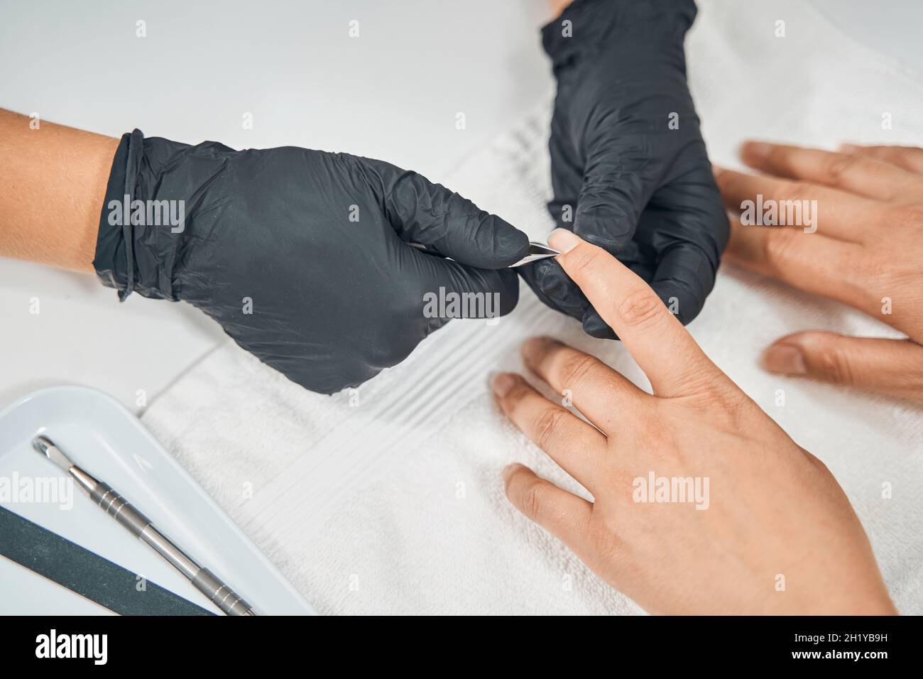 Close up of nail master doing manicure in salon Stock Photo - Alamy