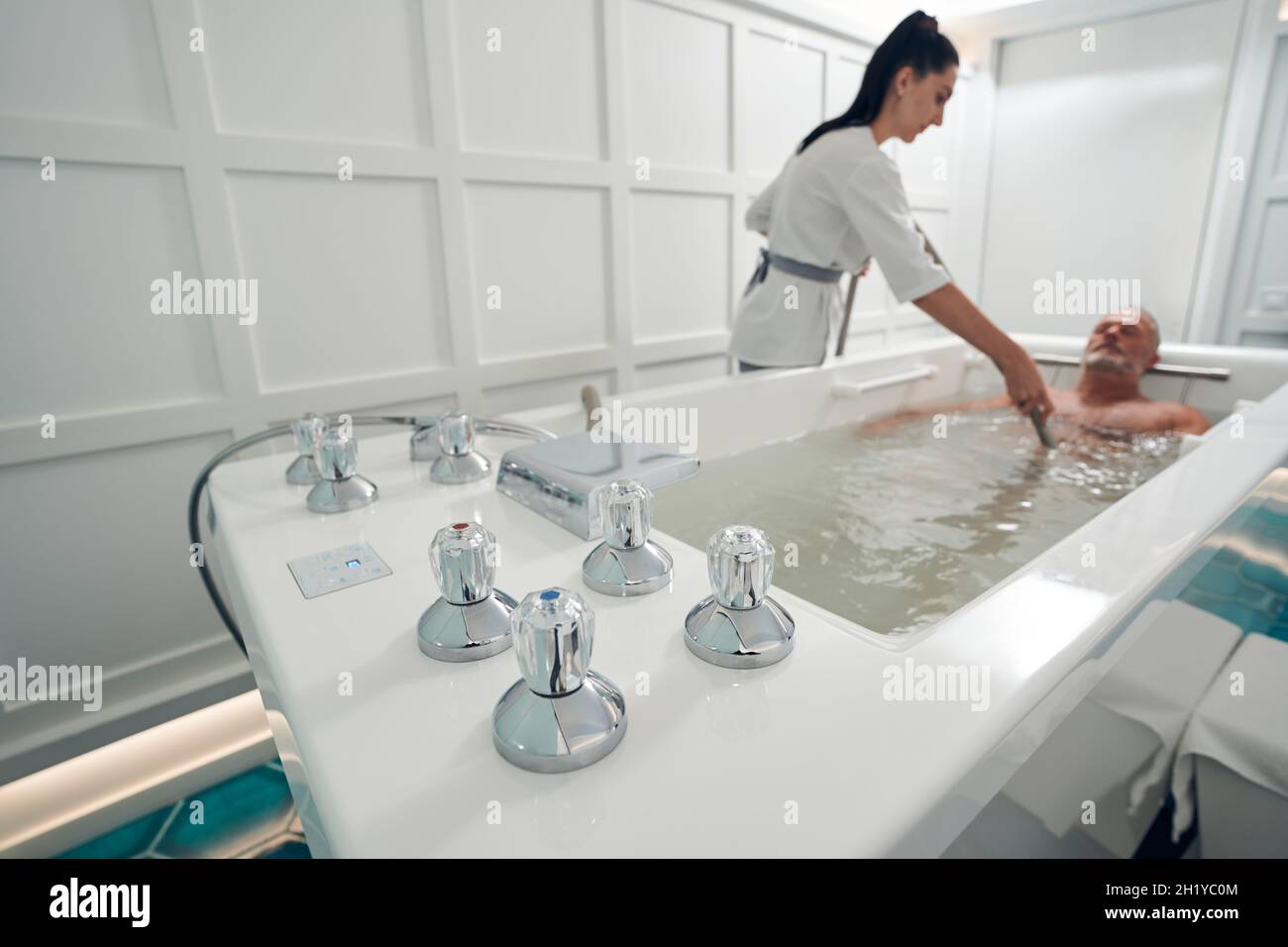 Man having hydrotherapy procedure at wellness center Stock Photo - Alamy