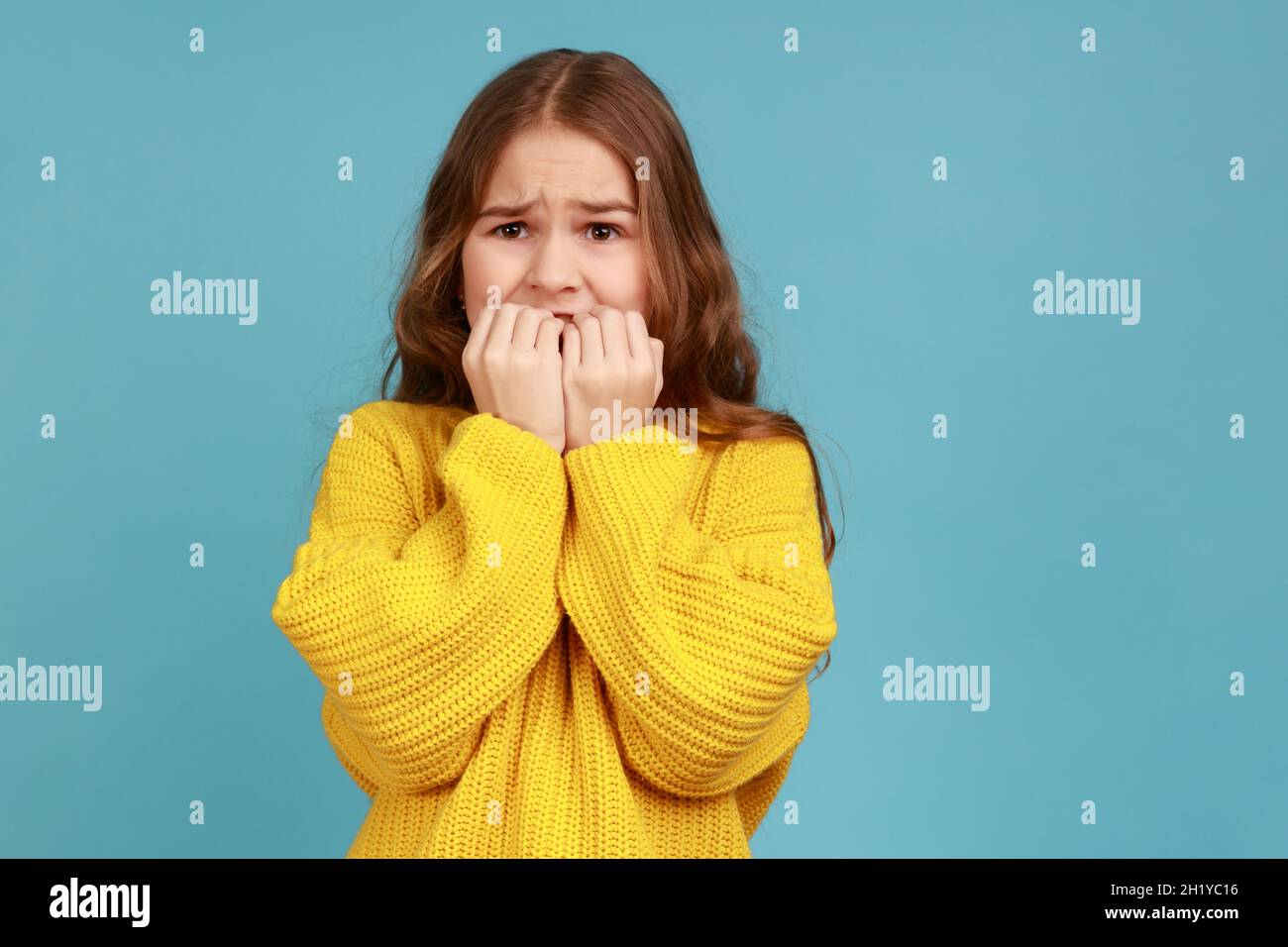 Little girl biting nails with scared big eyes, feeling worried, anxious ...