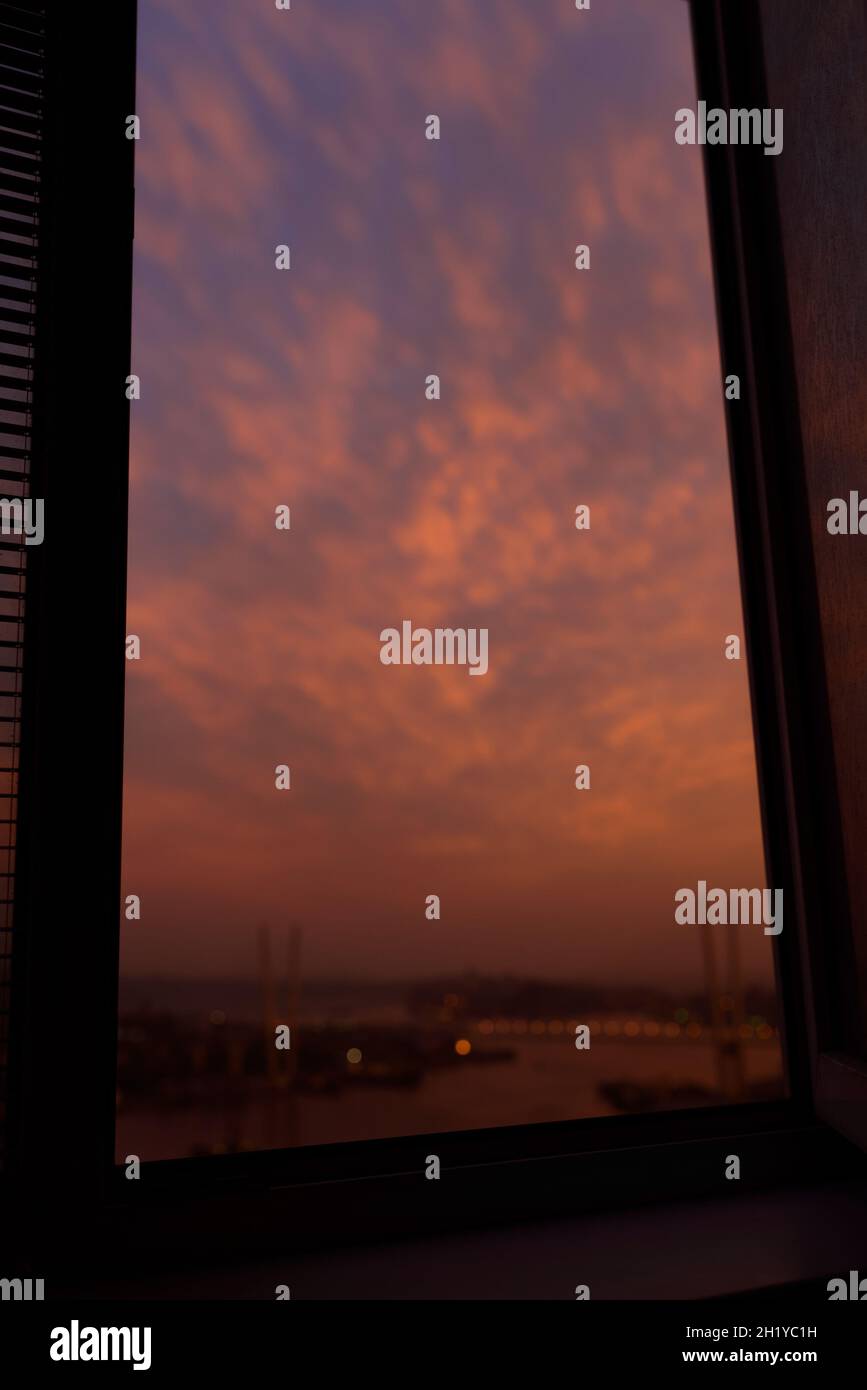 Sunset sky over city - view from window Stock Photo - Alamy